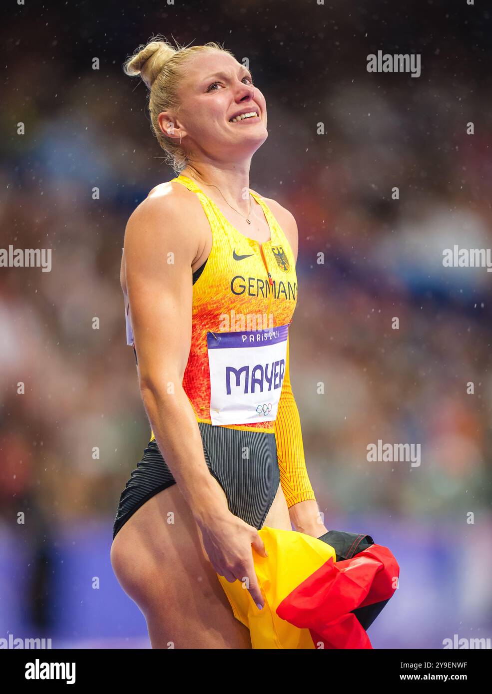 Lisa Mayer celebrating with her country's flag in the 4X100 meters ...