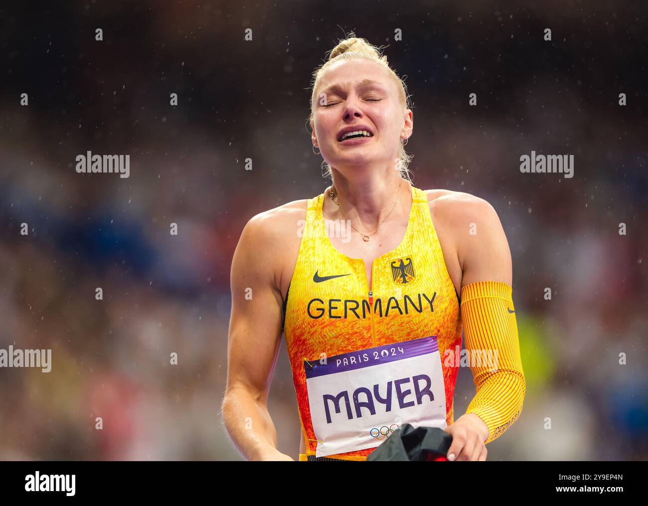 Lisa Mayer celebrating with her country's flag in the 4X100 meters ...