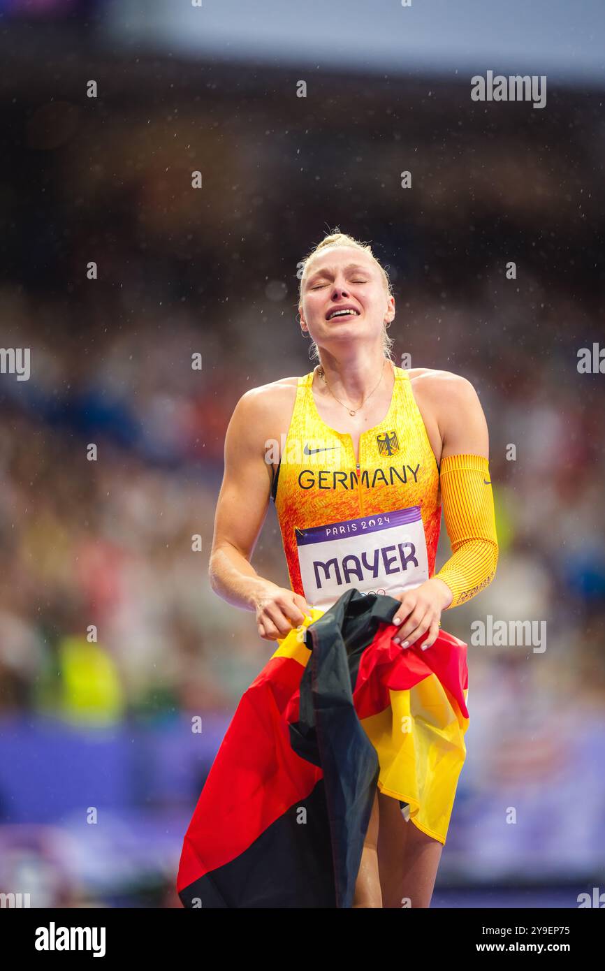 Lisa Mayer celebrating with her country's flag in the 4X100 meters ...