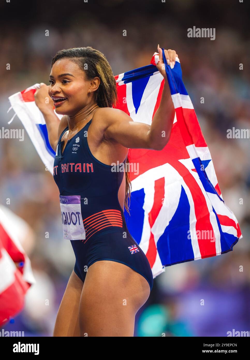 Imani-Lara Lansiquot celebrating with her country's flag in the 4X100 ...