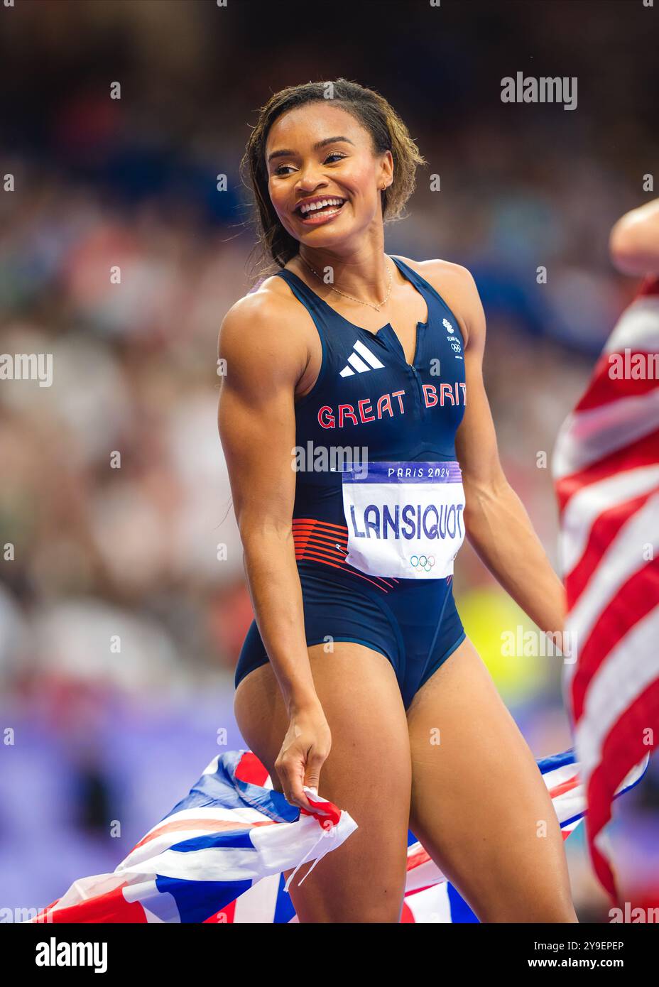 Imani-Lara Lansiquot celebrating with her country's flag in the 4X100 ...
