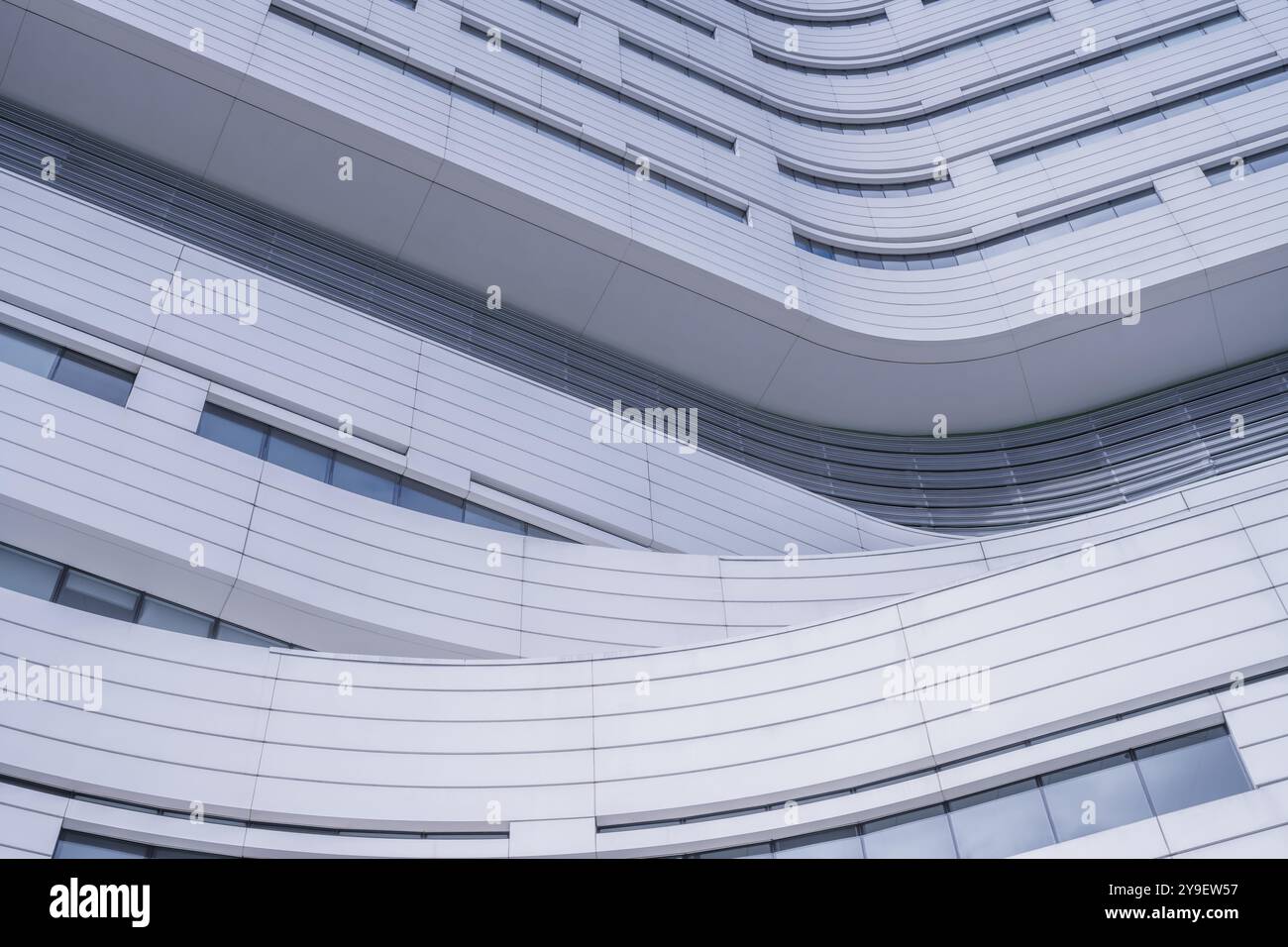 Sleek lines and curves define the modern architecture of a high-rise building, with multiple ...