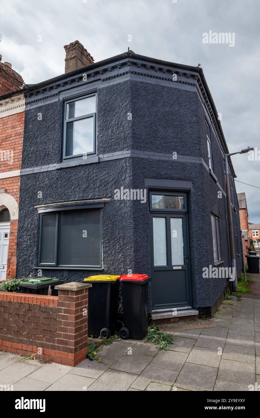 Grey painted victorian terraced house in a street of ordinary brick ...