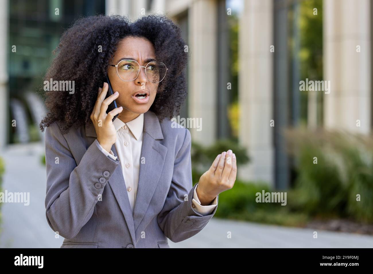Professional african american business woman in gray blazer engaged in ...