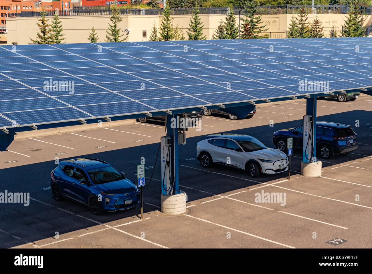 Duluth, MN, US-September 15, 2024: Electric cars charging in parking ...