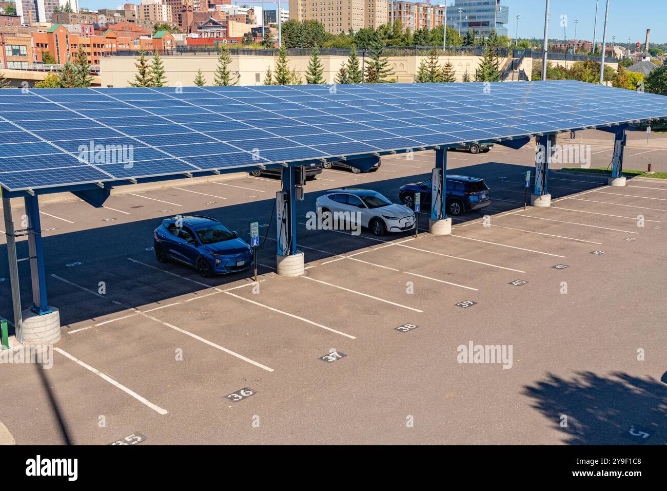 Duluth, MN, US-September 15, 2024: Electric cars charging in parking ...