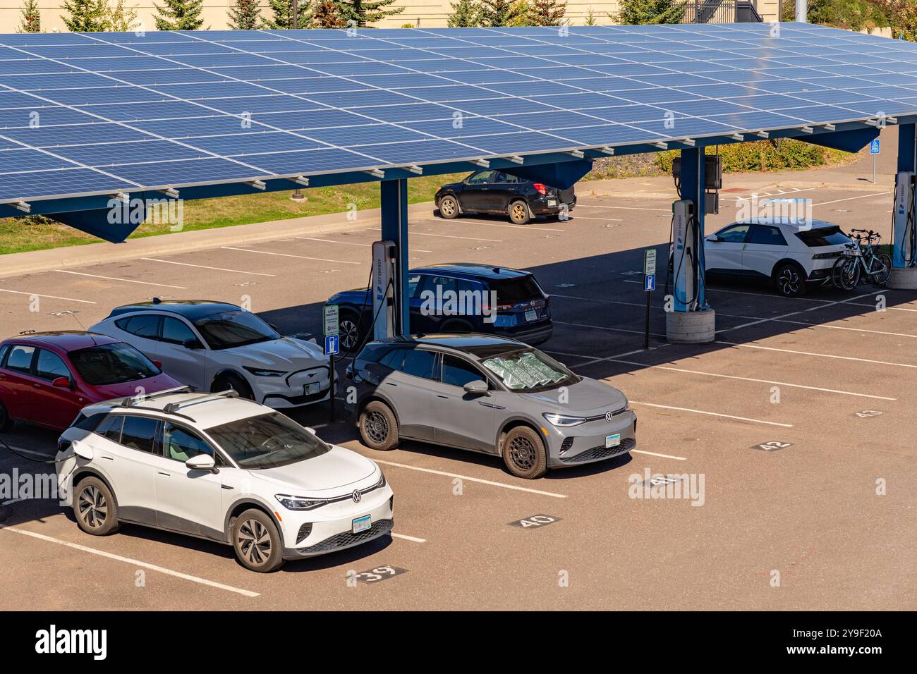 Duluth, MN, US-September 15, 2024: Electric cars charging in parking ...