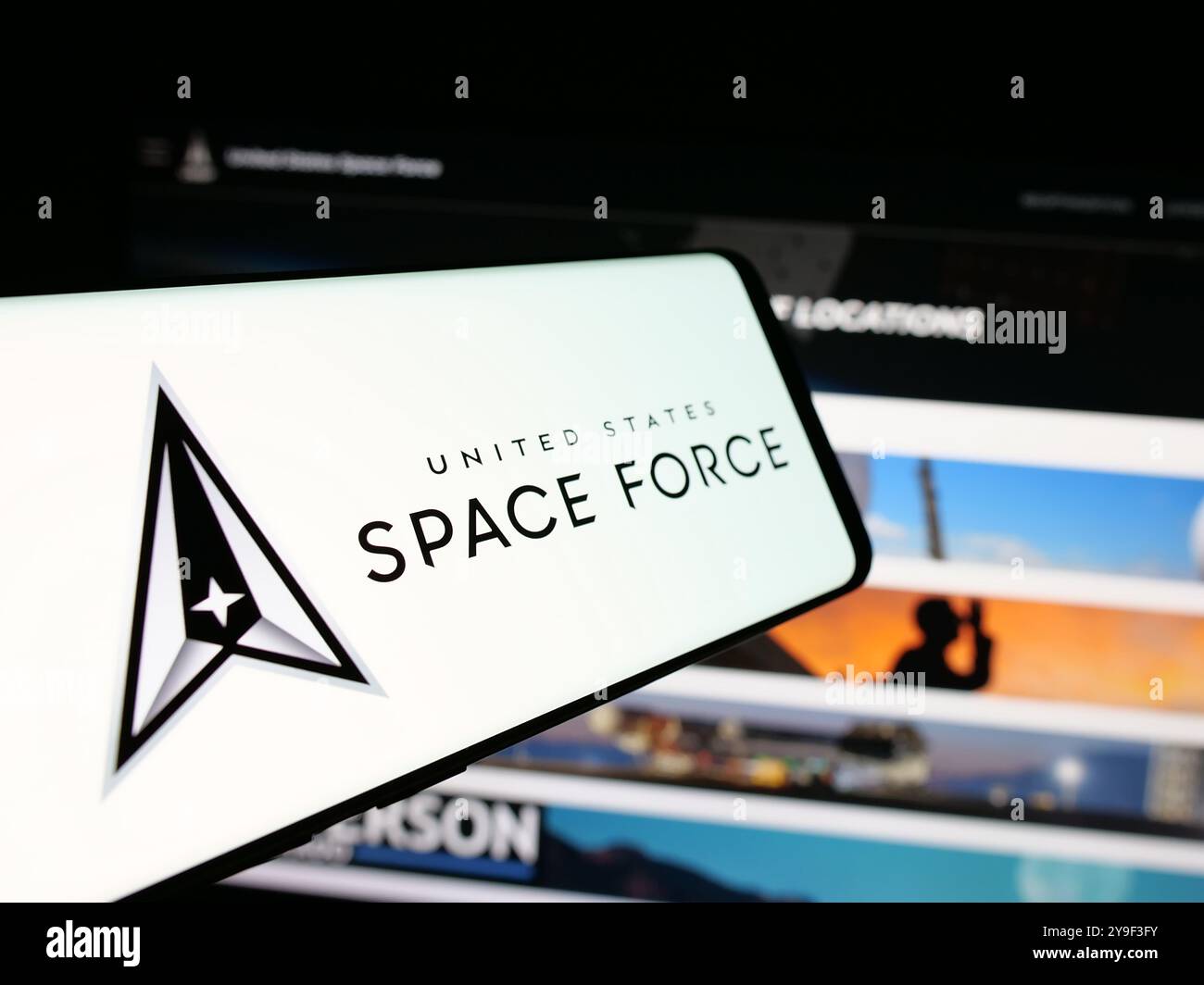 Cellphone with logo of United States Space Force (USSF) on screen in ...