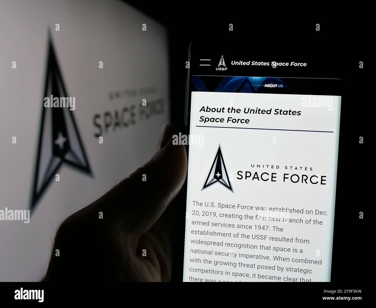 Person holding smartphone with webpage of United States Space Force ...