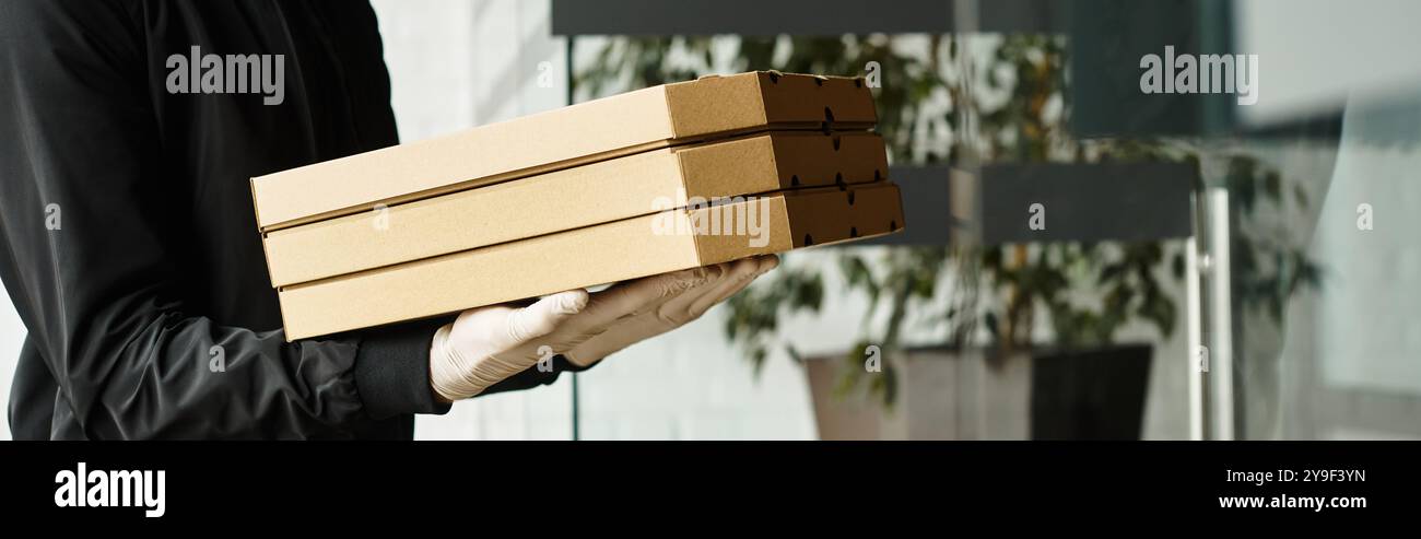 A delivery professional brings stacked packages to a bustling office ...