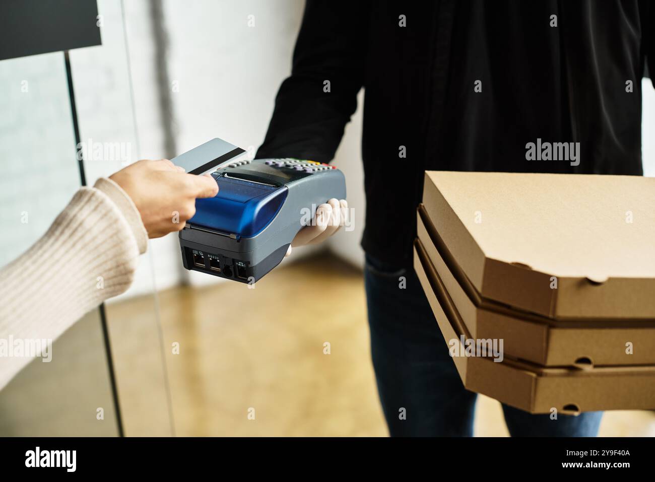 A delivery person arrives at an office building, handing over food ...