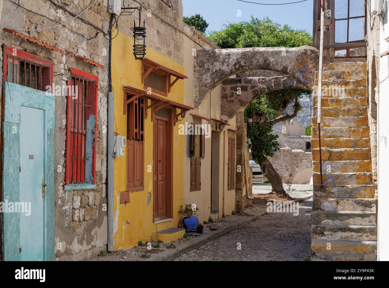 Quaint street view of rustic houses and stone stairs painted in pastel ...