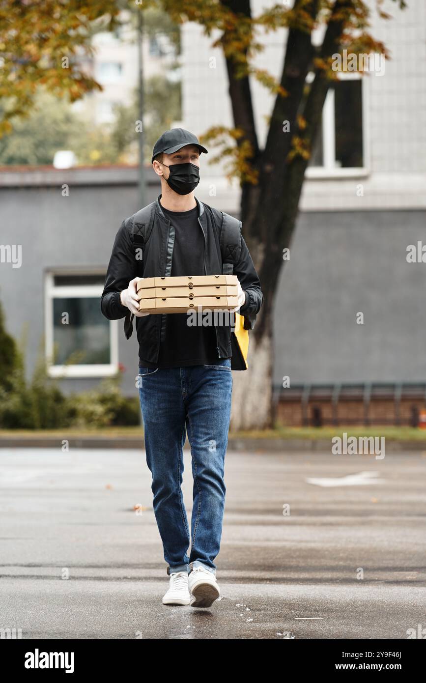 A delivery man steps into an office building, carrying multiple food ...