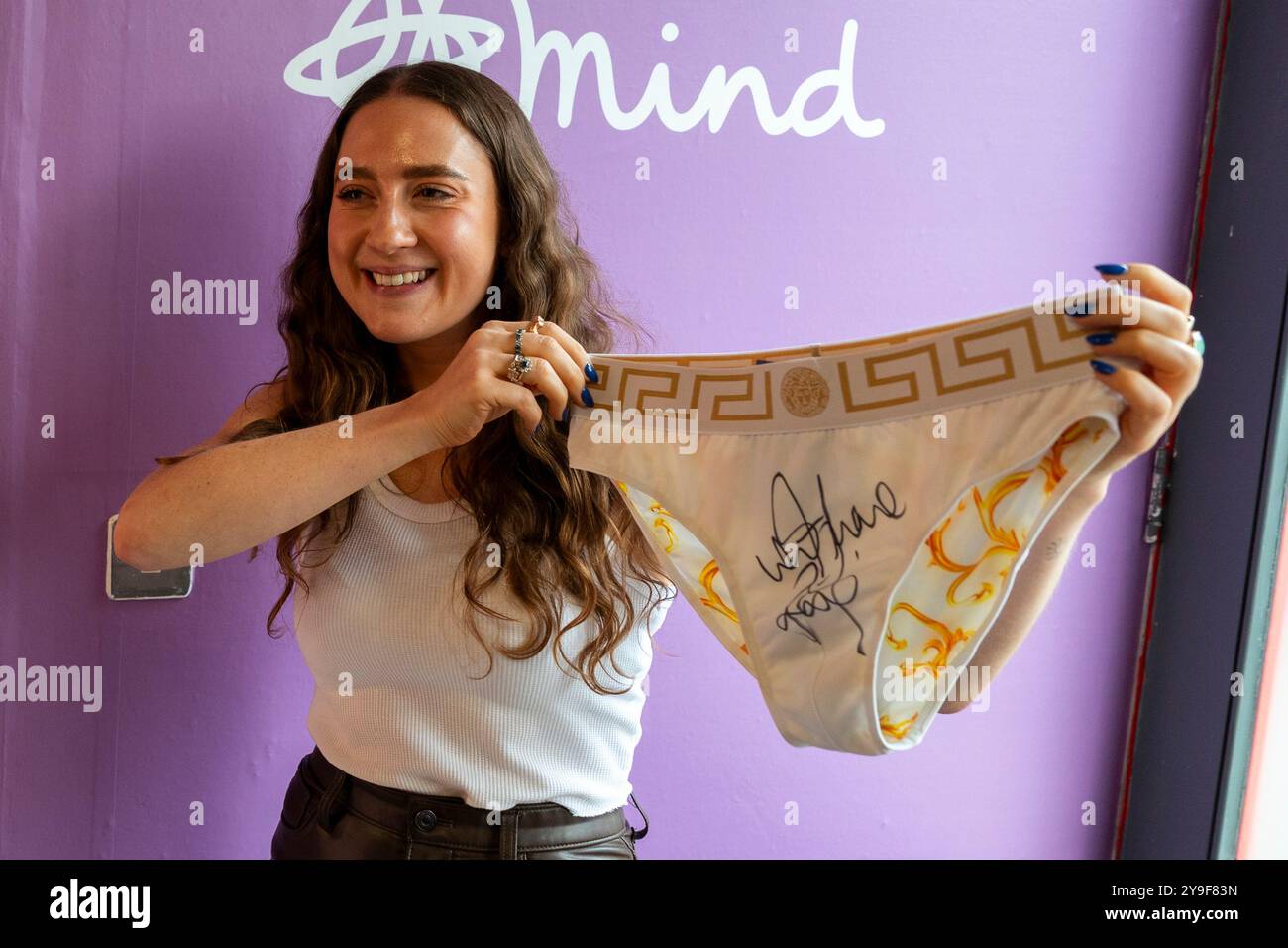 Versace pants signed by Robbie Williams during a preview of the Netflix ...