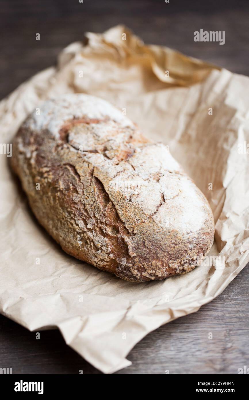 Crusty loaf of sourdough bread on brown paper Stock Photo - Alamy