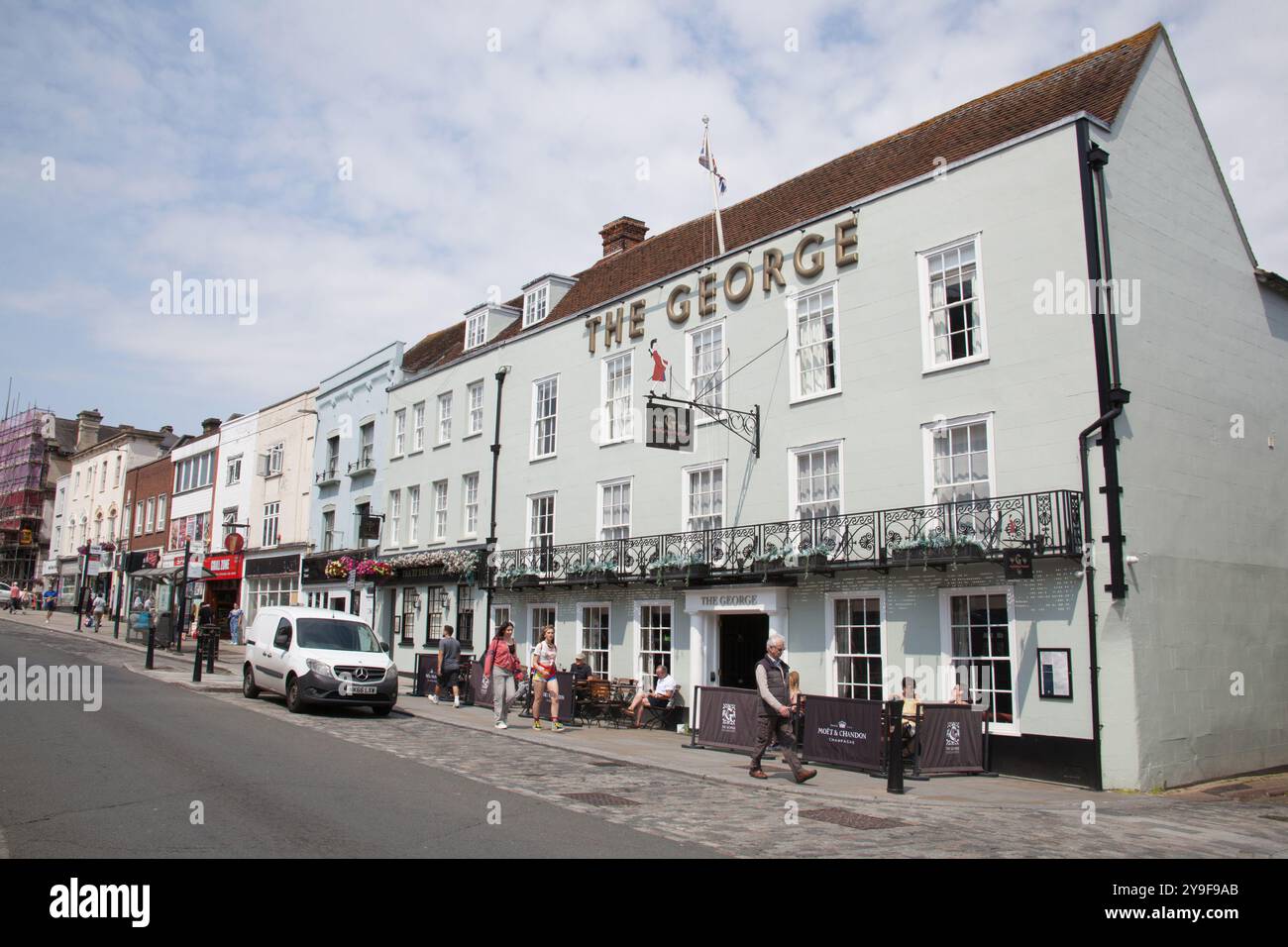 The George Hotel and shops on The High Street in Colchester, Essex in ...