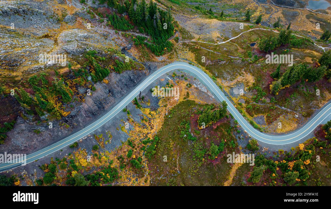 Aerial view of a highway twisting through alpine tundra landscape in ...