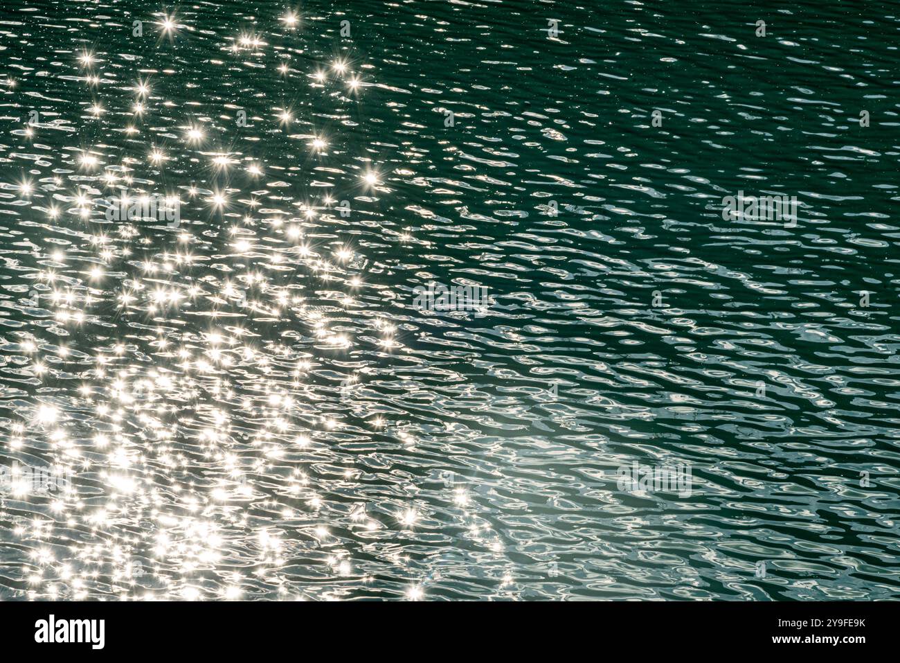 Stunning water shimmering on with sun reflecting on the service with ...