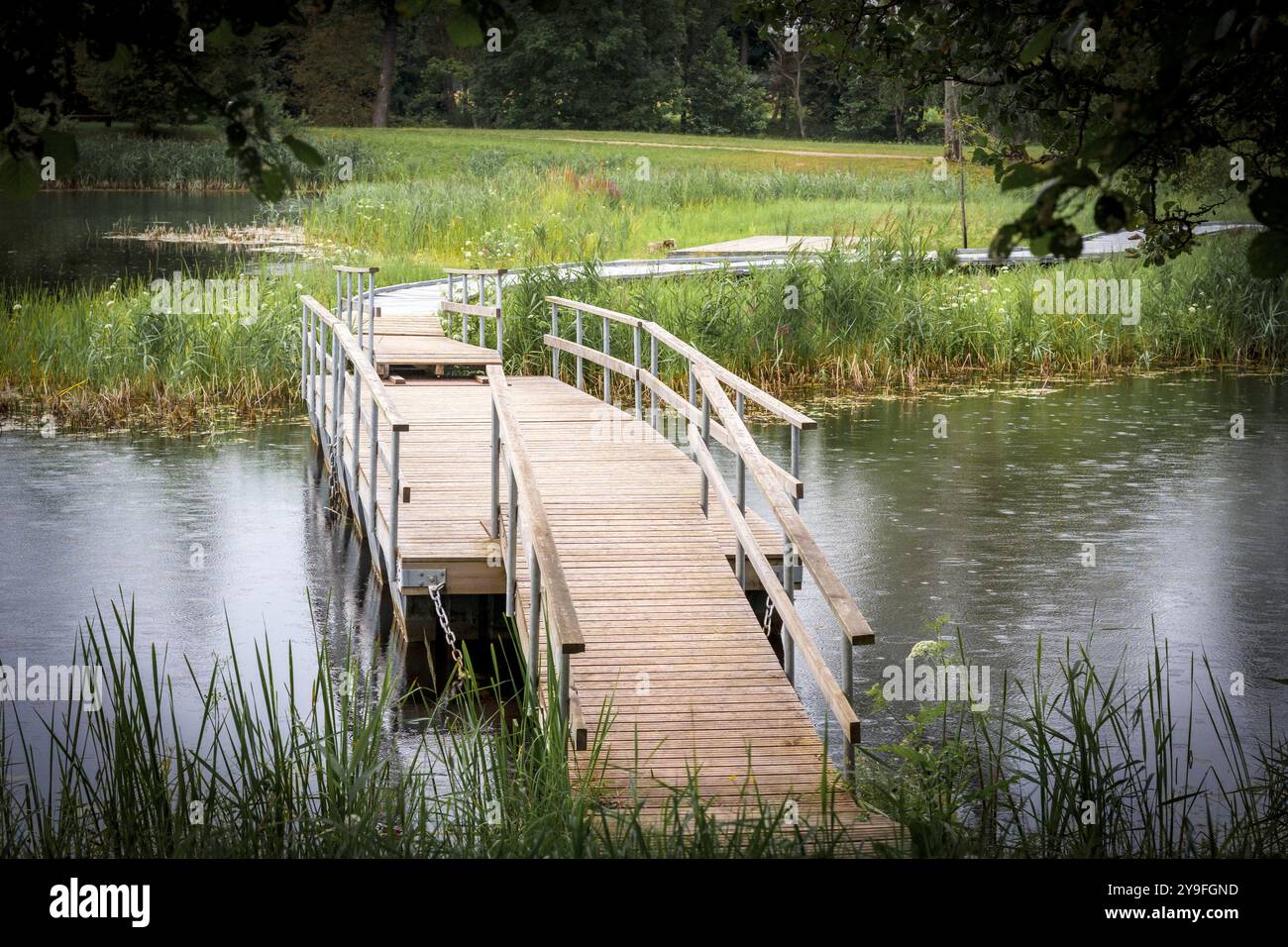 wooden bridge in the park over the water body Stock Photo - Alamy
