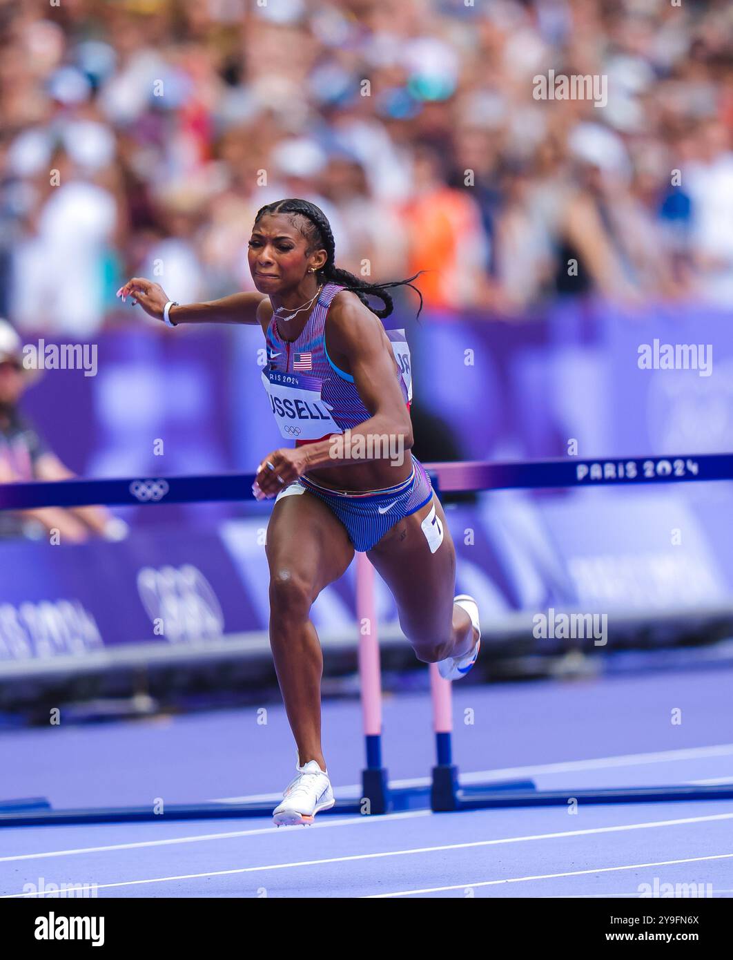 Masai Russell participating in the 100 meters hurdles at the Paris 2024 ...
