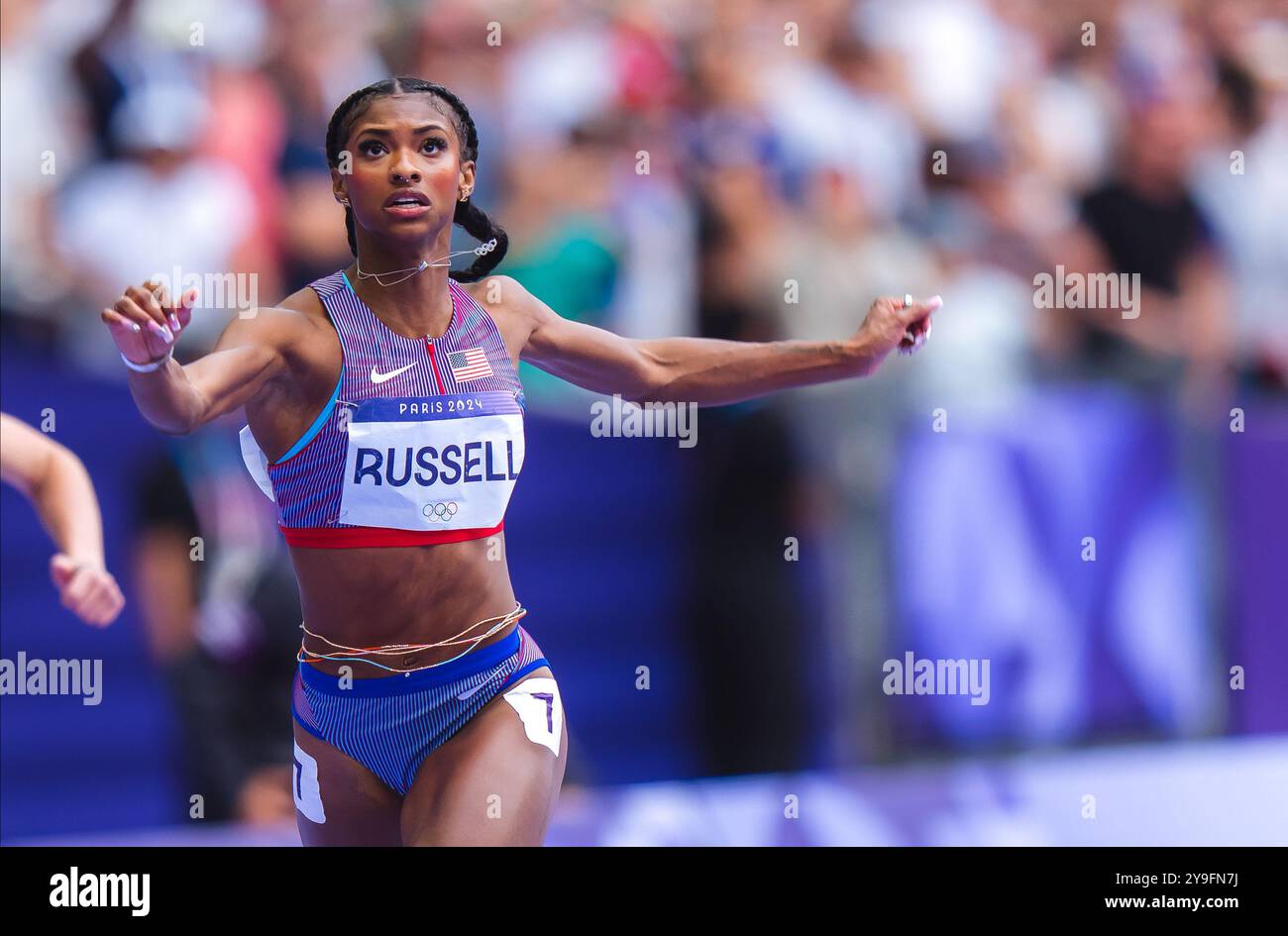 Masai Russell participating in the 100 meters hurdles at the Paris 2024 ...