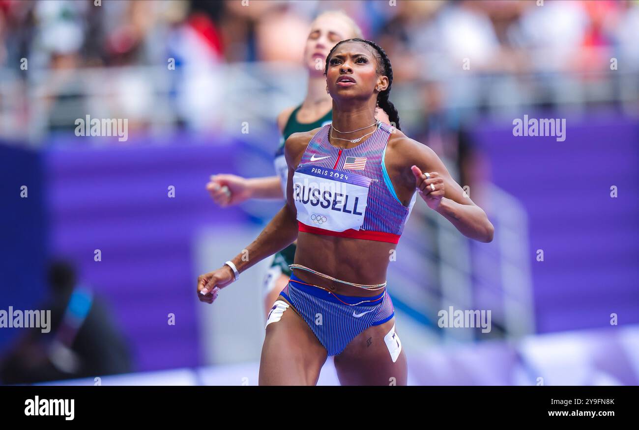Masai Russell participating in the 100 meters hurdles at the Paris 2024 ...