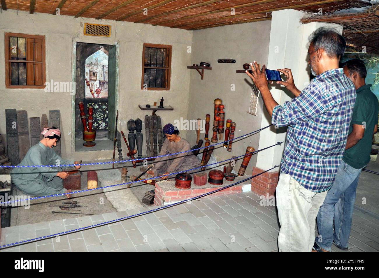 Visitors take keen interest in pictures and sculptures during Sindh ...