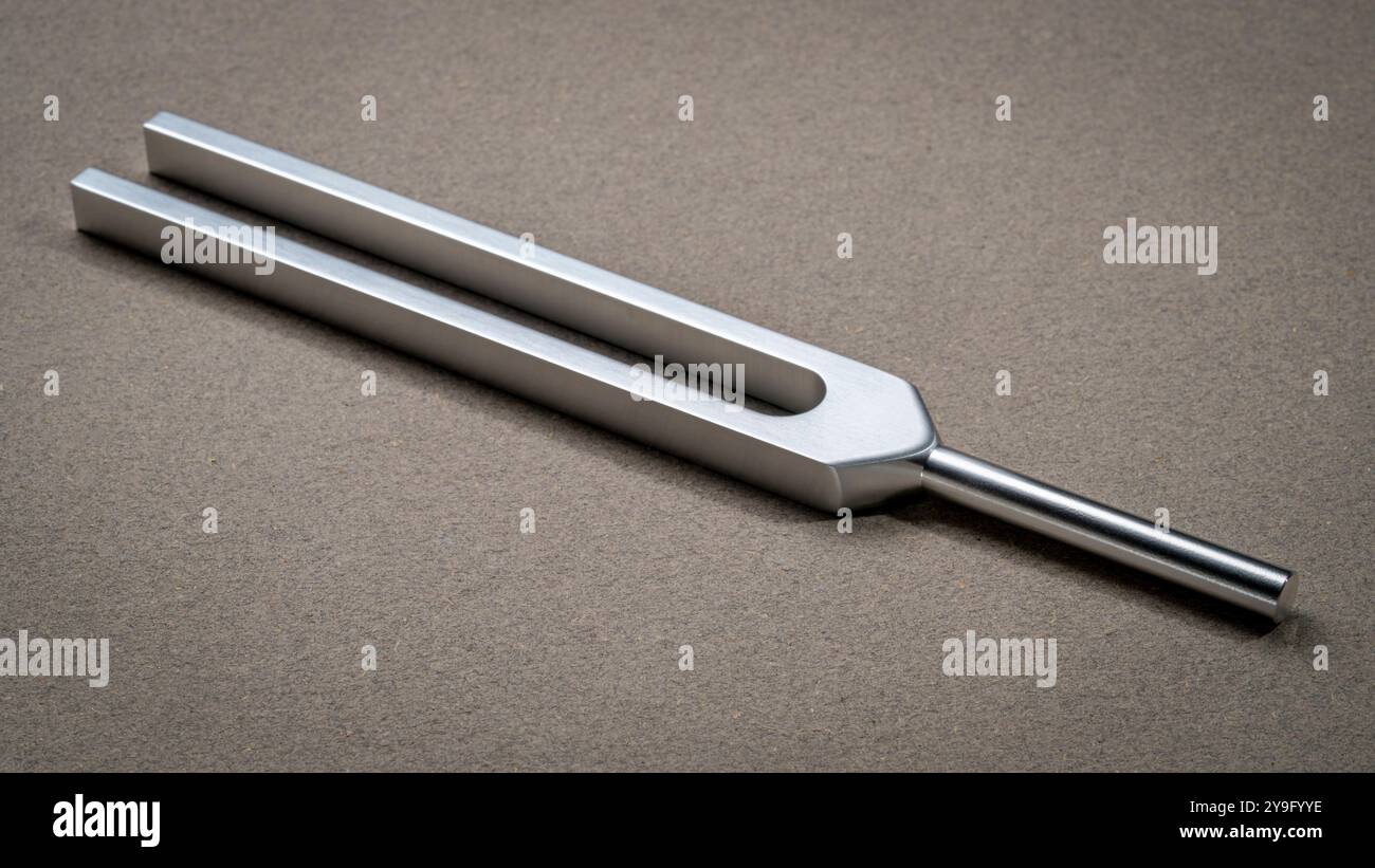 Metal tuning fork used for tuning musical instruments, sound therapy or ...