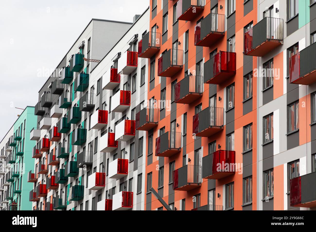 Colorful high-rise apartment buildings line a residential area, with ...