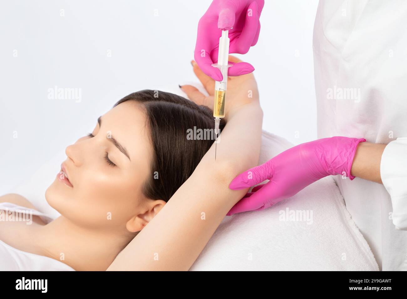 Doctor doing stem cell therapy on a patient's elbow after the injury. Treating knee pain with ...