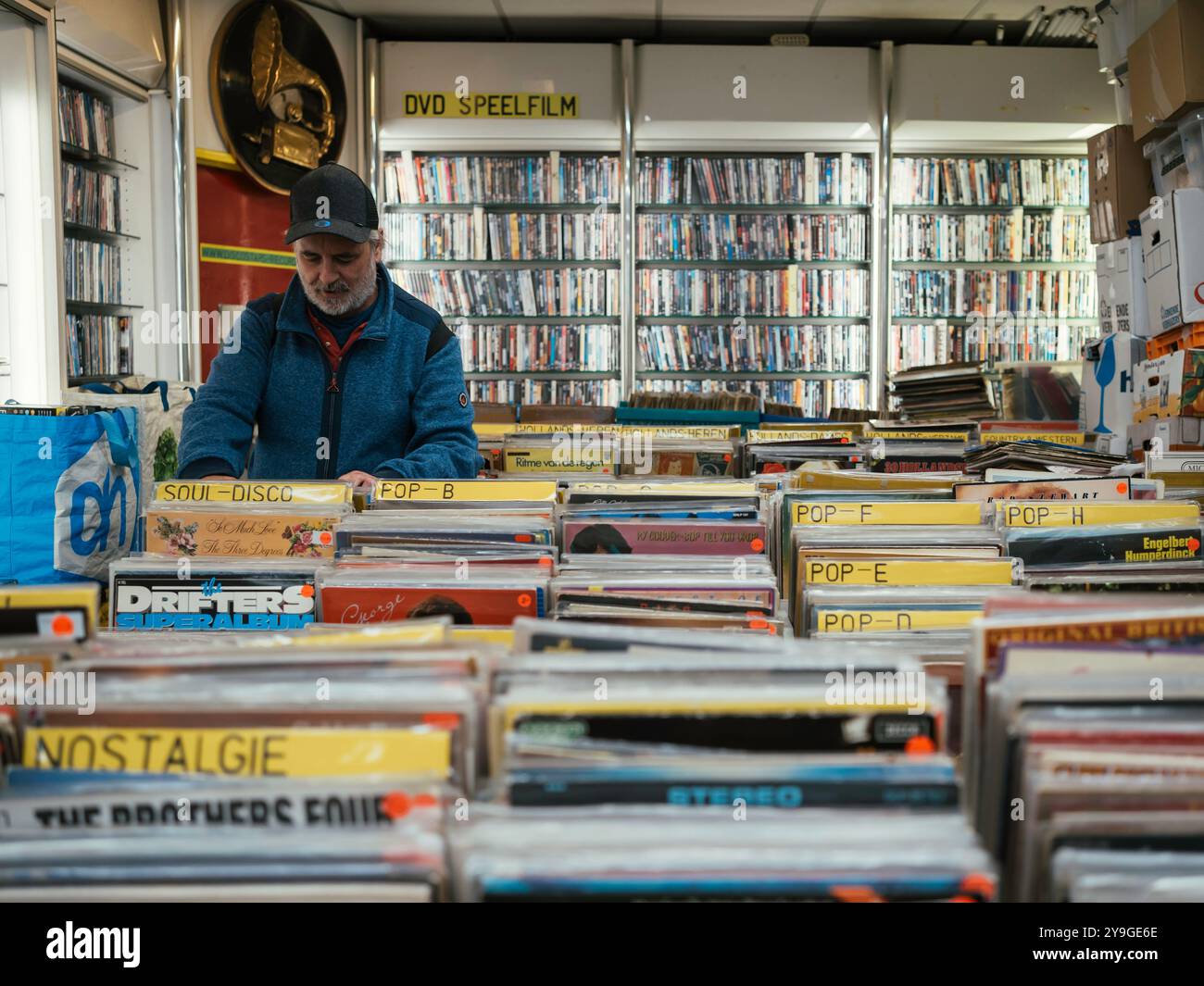 Interior of record shop, multitude of vinyl and cd. Man looking through ...