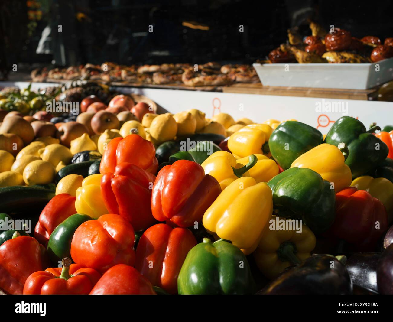 Vegetables and fruits on display front store. Bell peppers of all ...