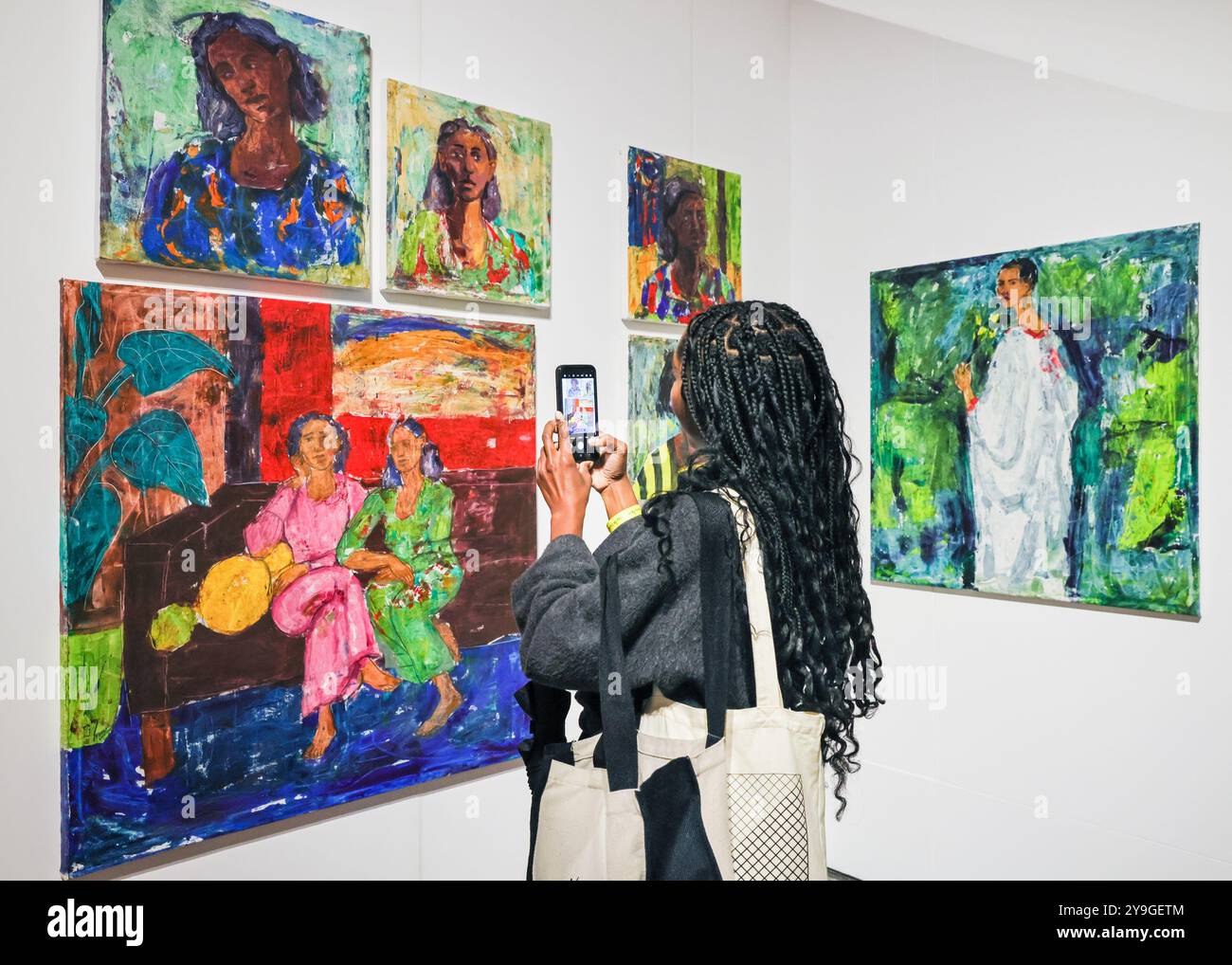 London, UK. 10th Oct, 2024. A visitor takes photos of Fikradis Lamesgen ...