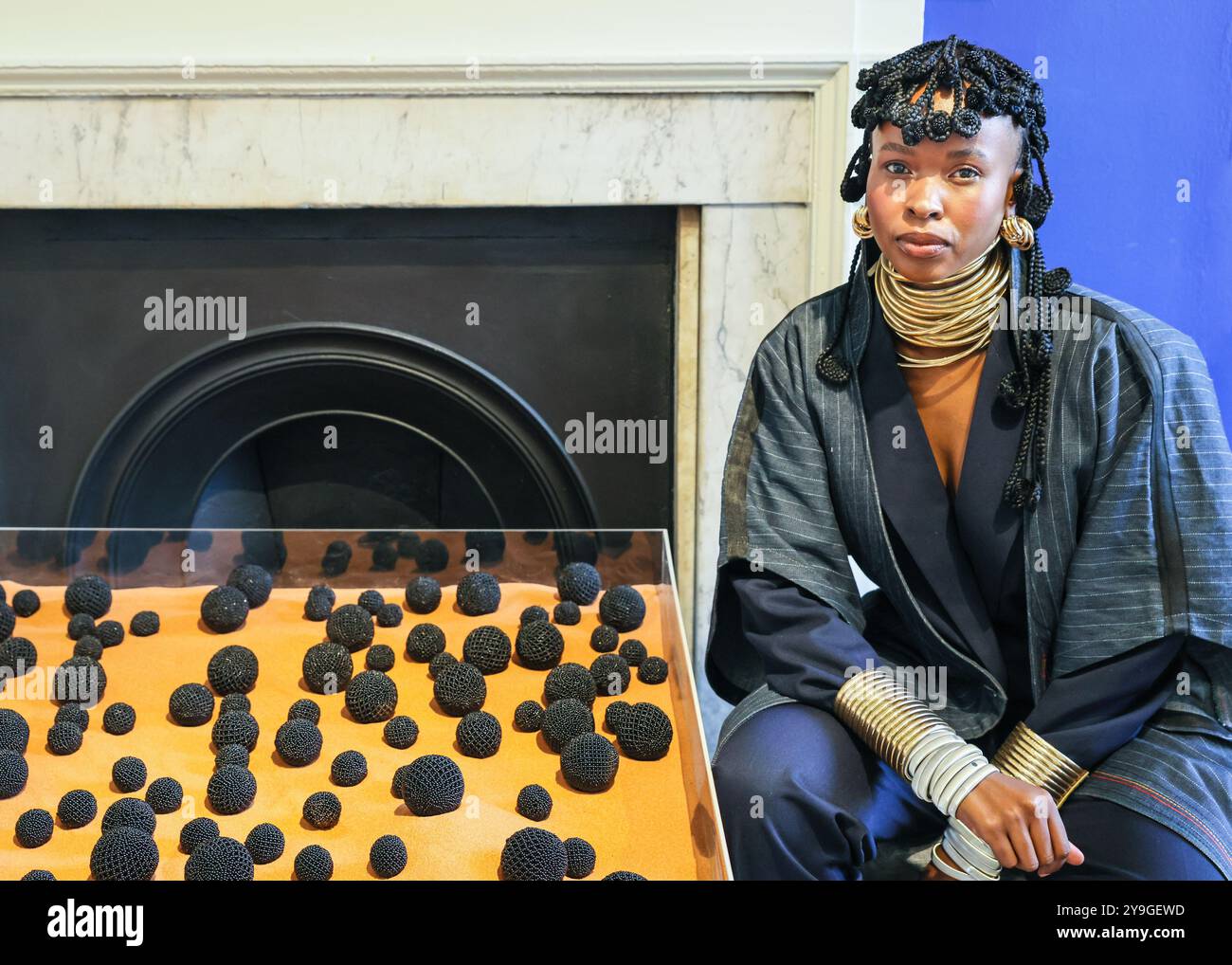 London, UK. 10th Oct, 2024. Artist Zana Masombuka with her work Is ...