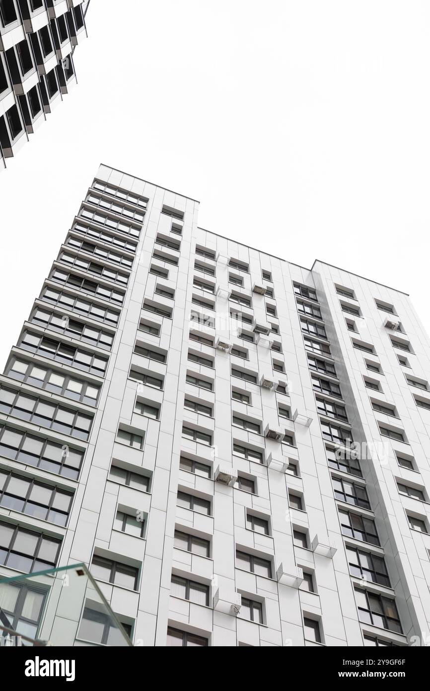 Modern high-rise apartment buildings in a residential area reflect ...