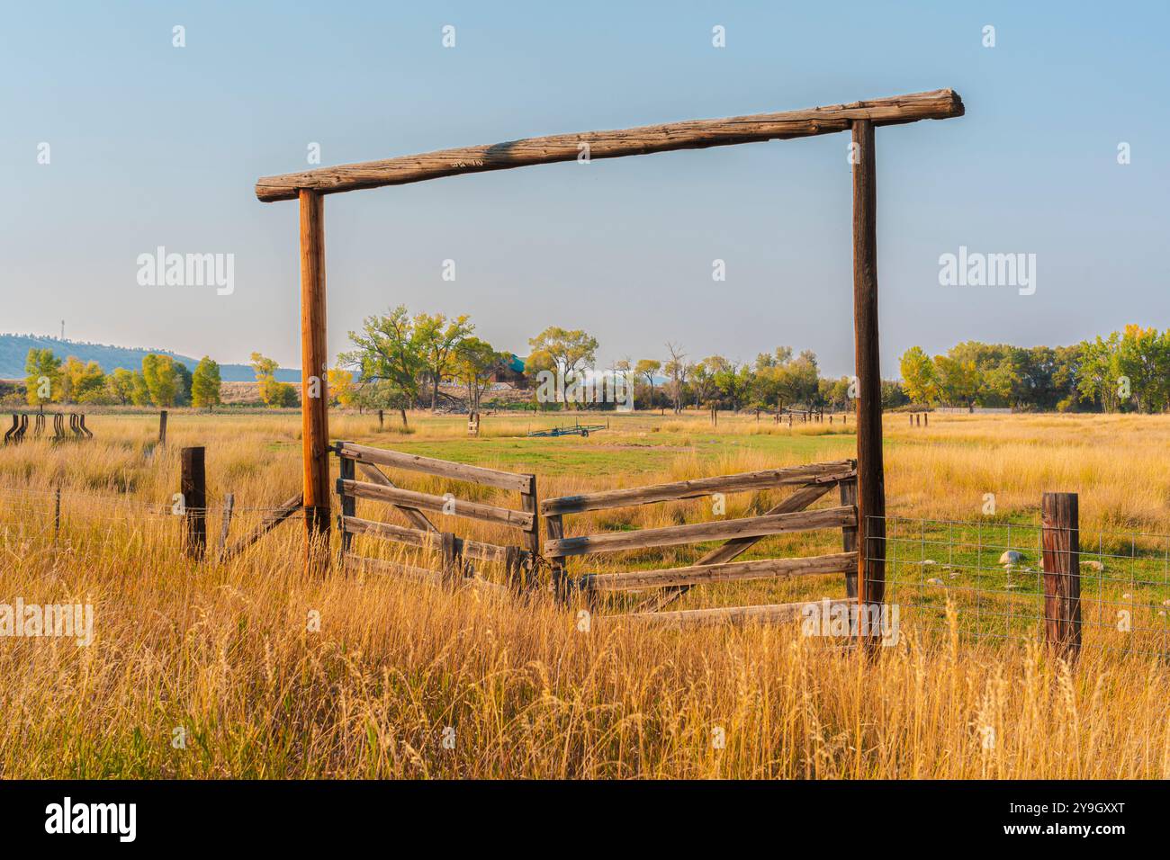 Old wood gate entrance with side & top wooden poles designates entry ...