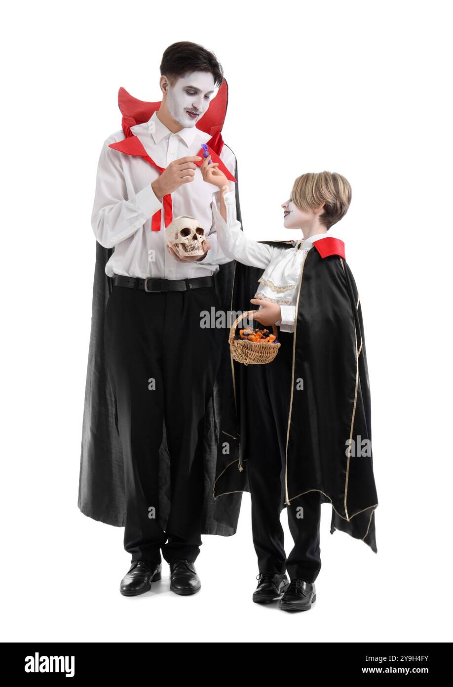 Little boy and his father dressed for Halloween as vampires with ...
