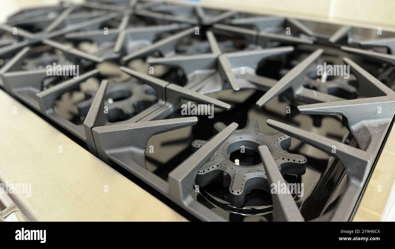 a gas stove's black, cast iron burners with sharp, angular design ...