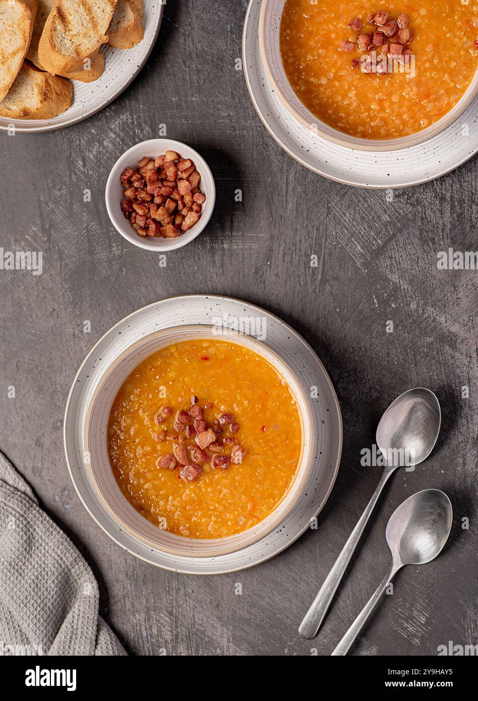 Food photography of red lentil soup with chili and bacon, carrot, onion ...