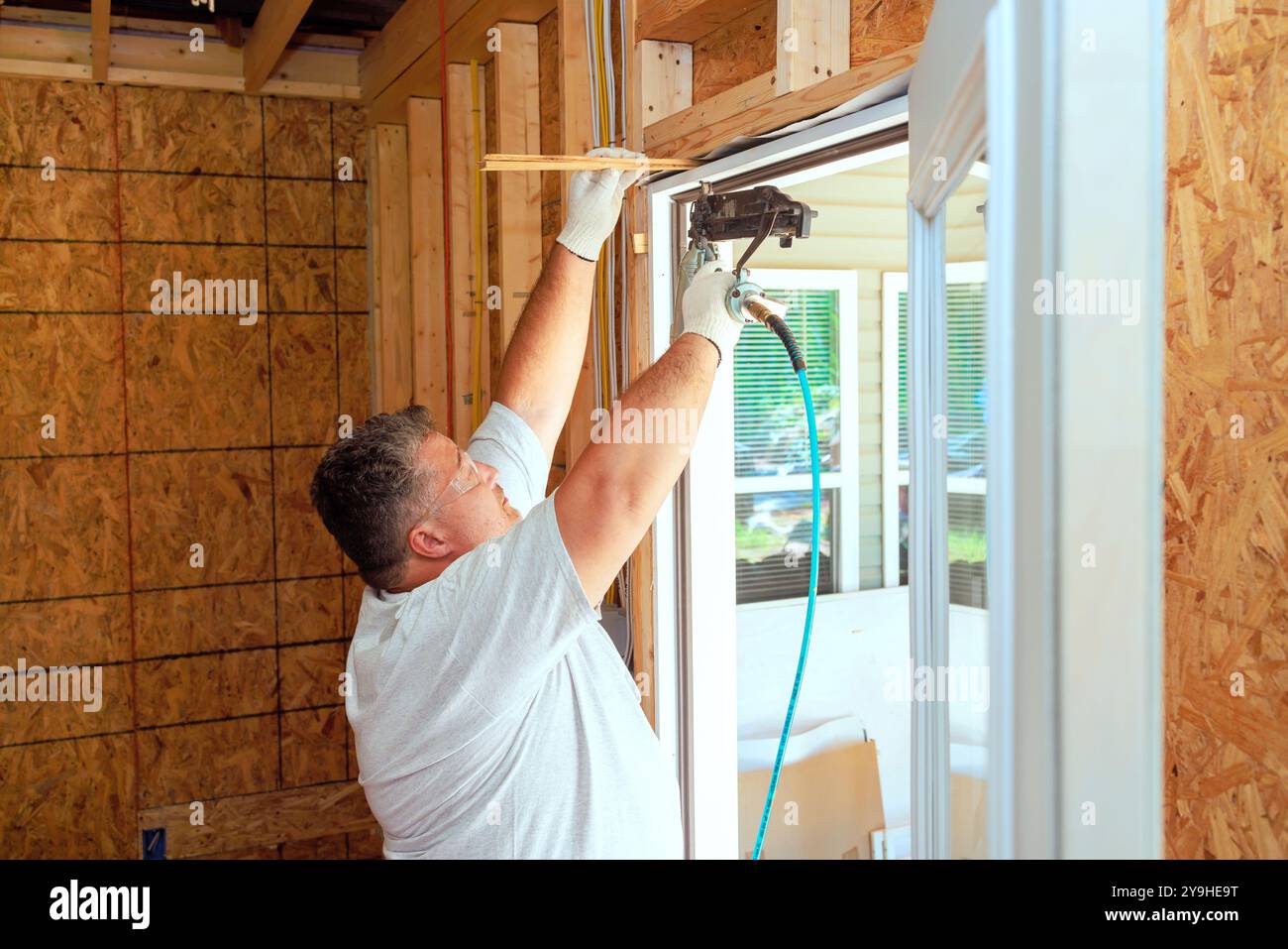 Installing front door of new home by professional carpenter Stock Photo ...