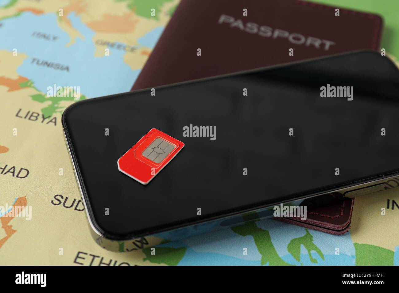 SIM card, smartphone and passport on world map, closeup Stock Photo - Alamy
