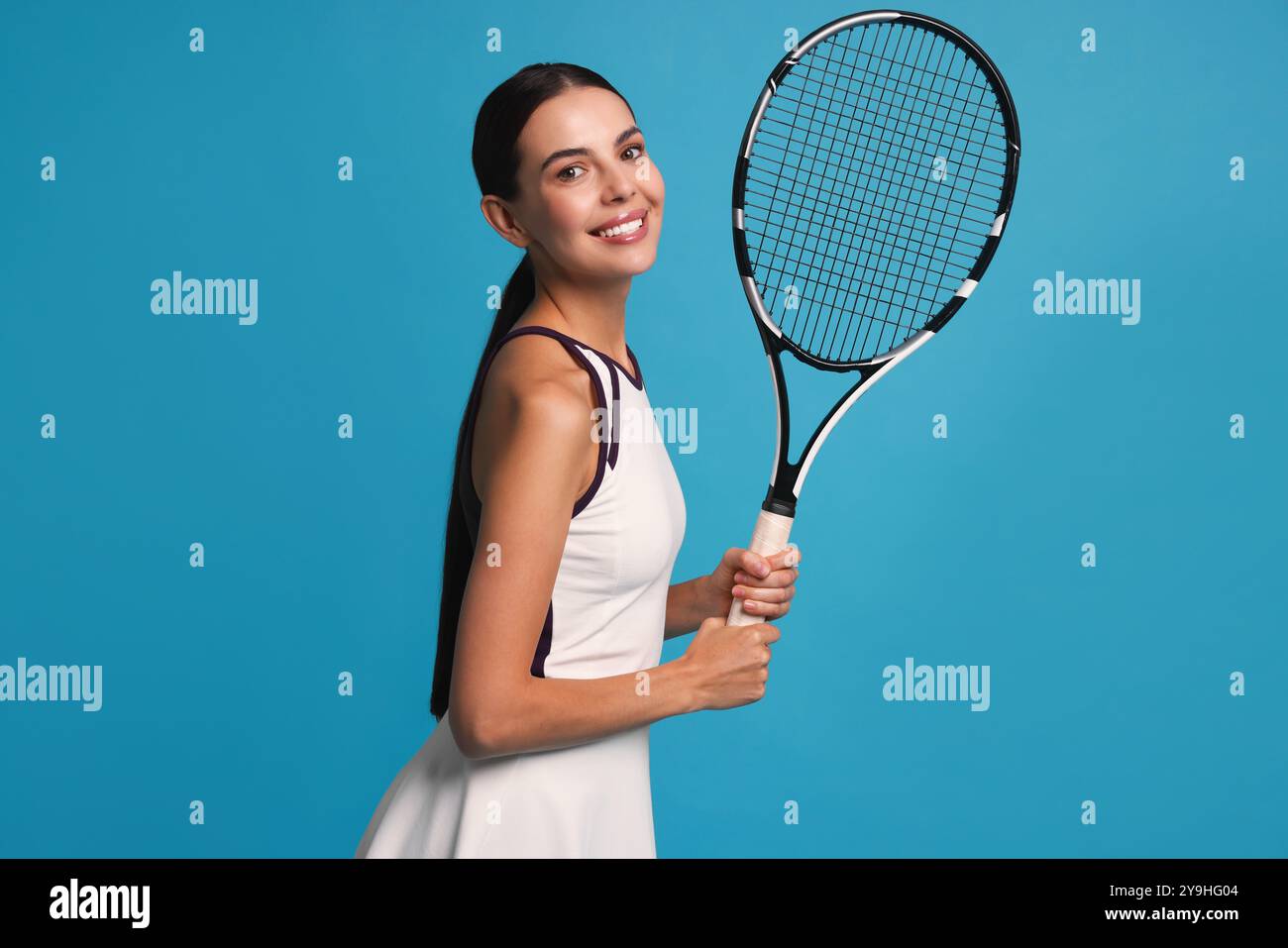 Beautiful young woman with tennis racket on light blue background Stock ...