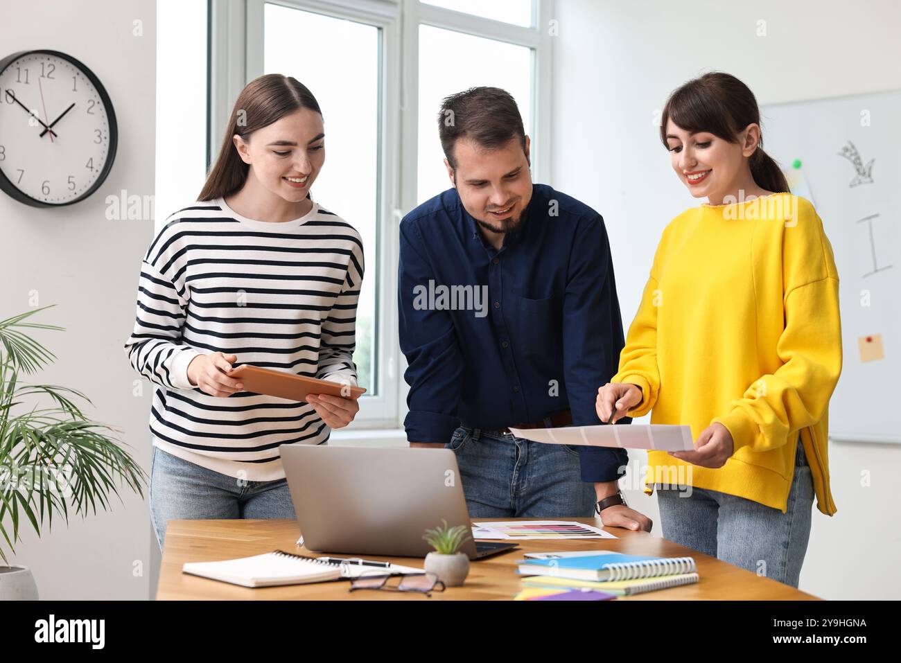 Group of designers working together in office Stock Photo - Alamy