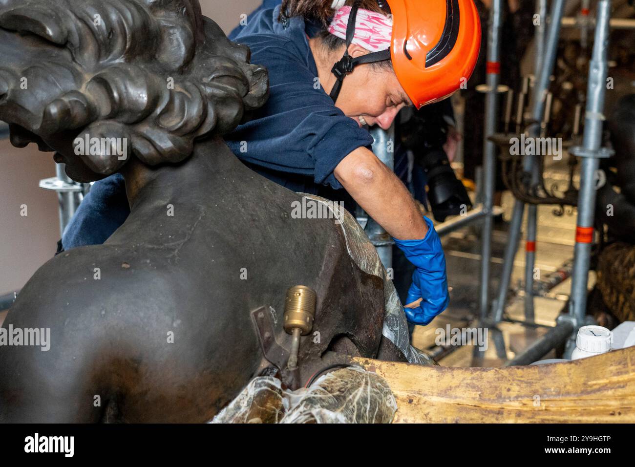 A restorer at work in the restoration site of the Altar of the Chair of ...