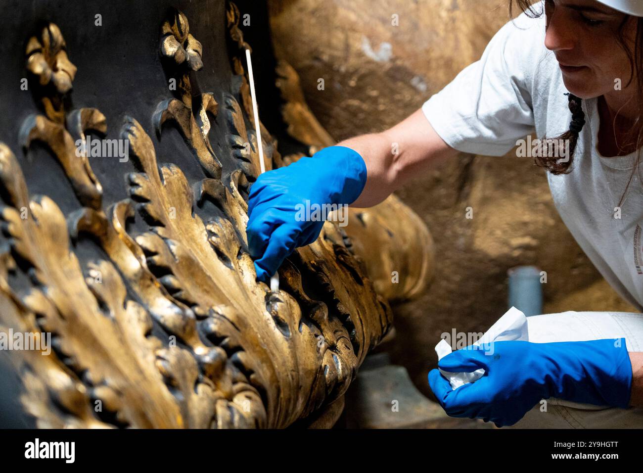 A restorer at work in the restoration site of the Altar of the Chair of ...