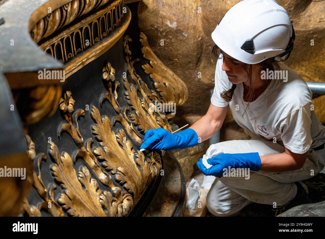 A restorer at work in the restoration site of the Altar of the Chair of ...