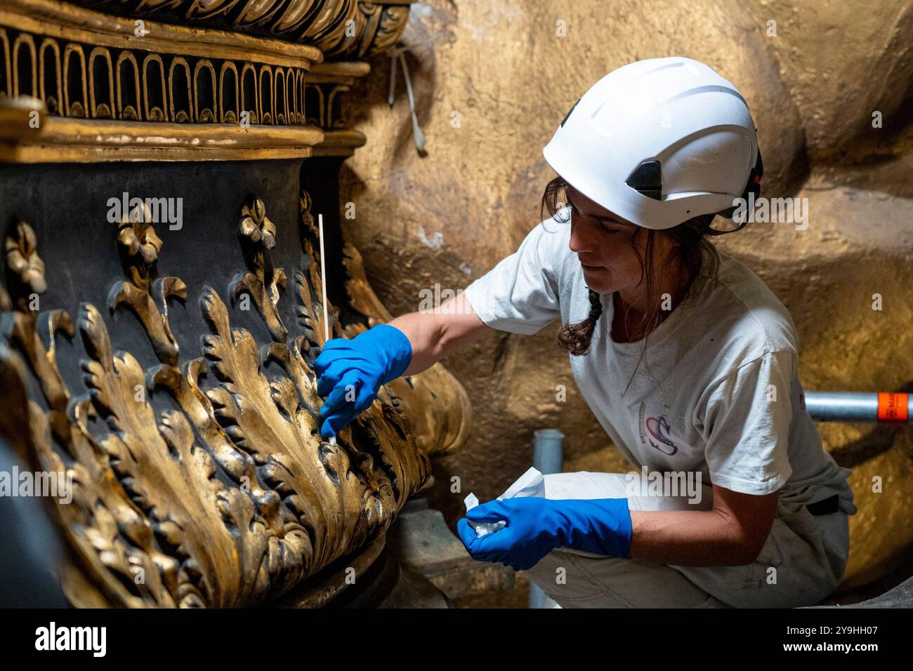 A restorer at work in the restoration site of the Altar of the Chair of ...