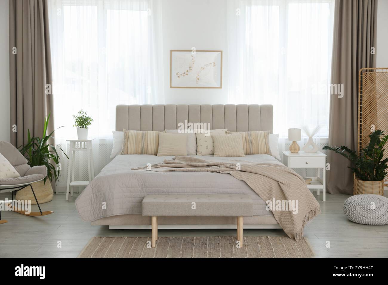 Big comfortable bed in room. Interior design Stock Photo - Alamy