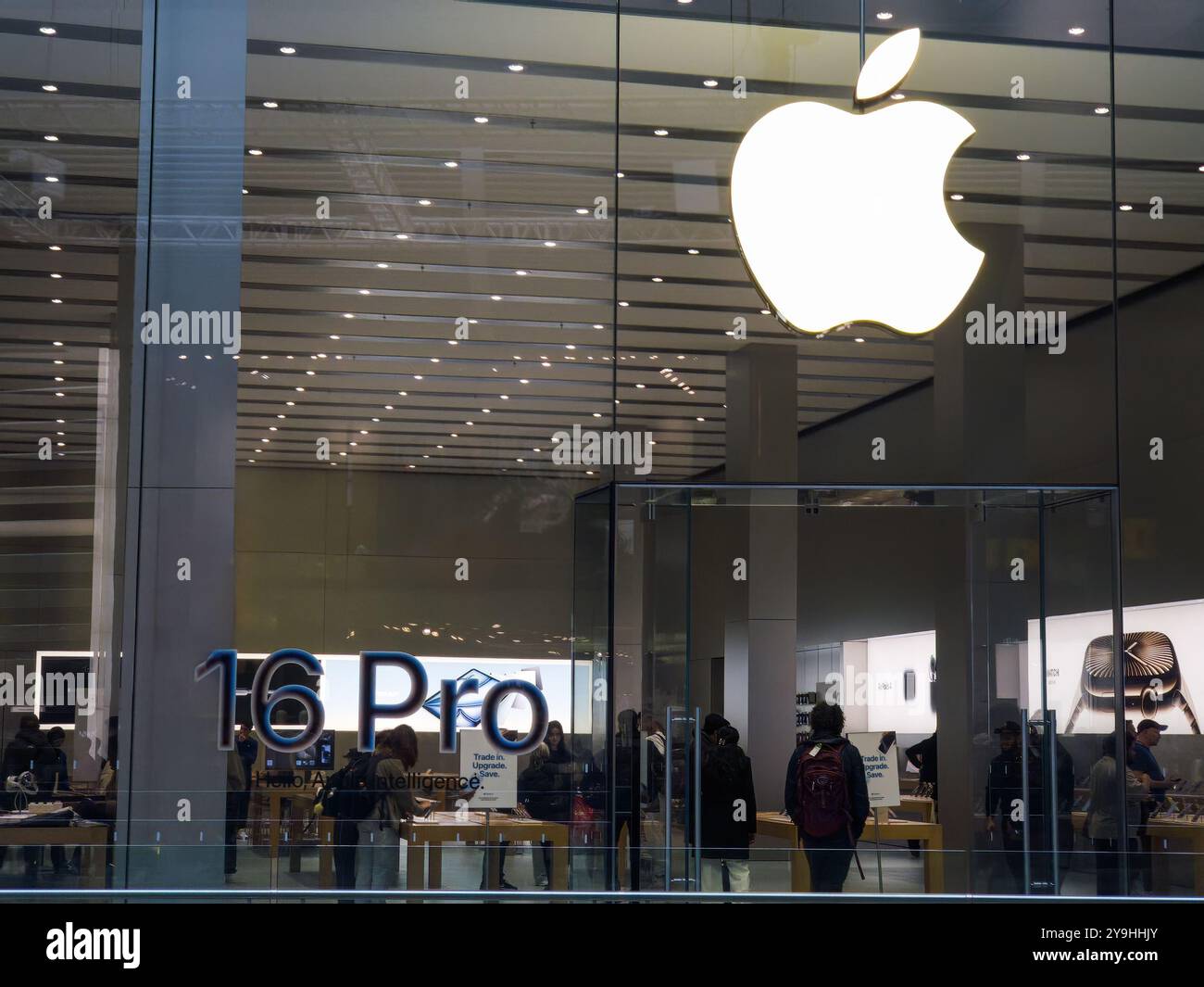 A sleek storefront window display with Apple logo, highlighting the ...