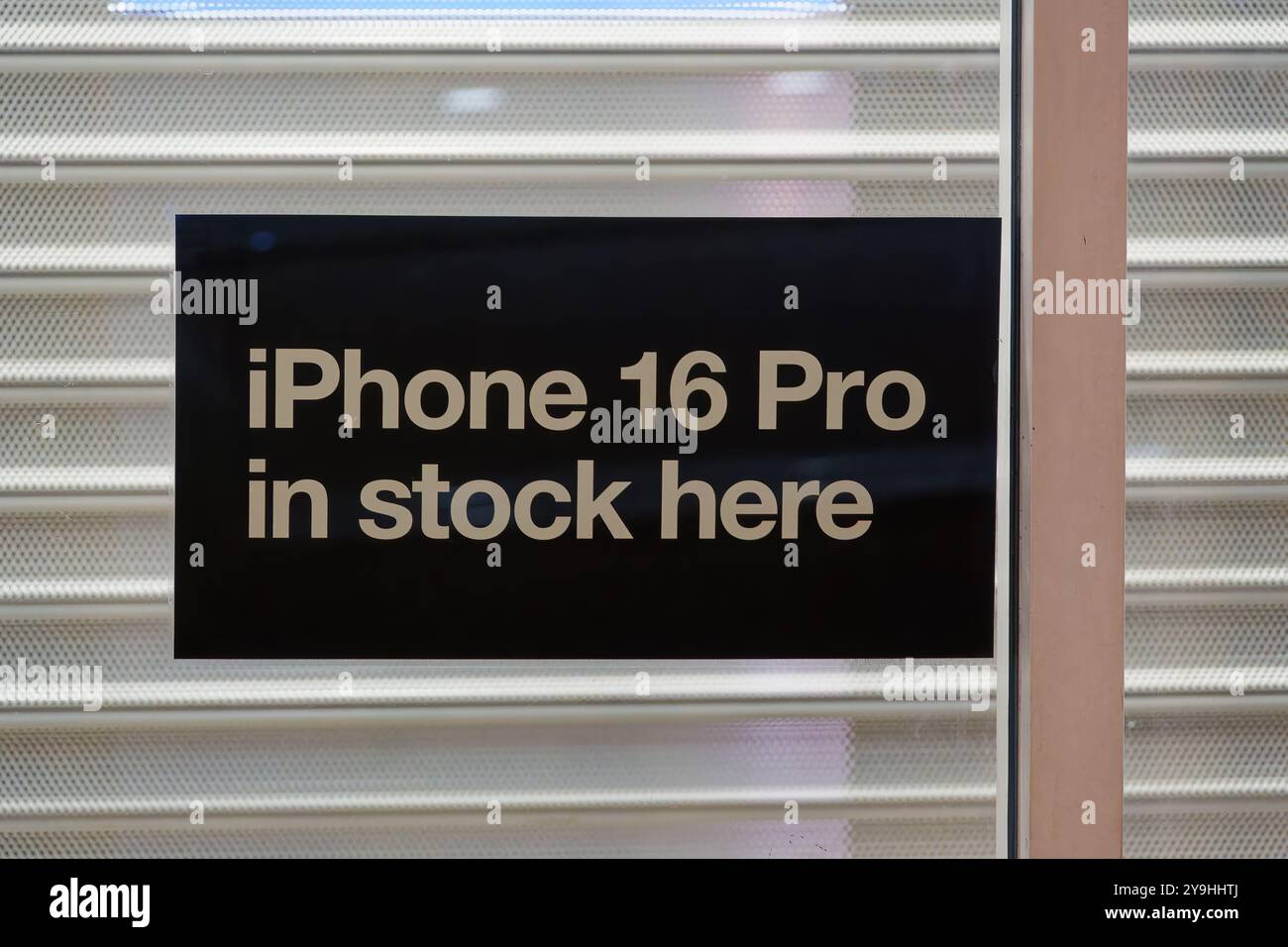 Sign indicating availability of the iPhone 16 Pro in stock at a retail ...